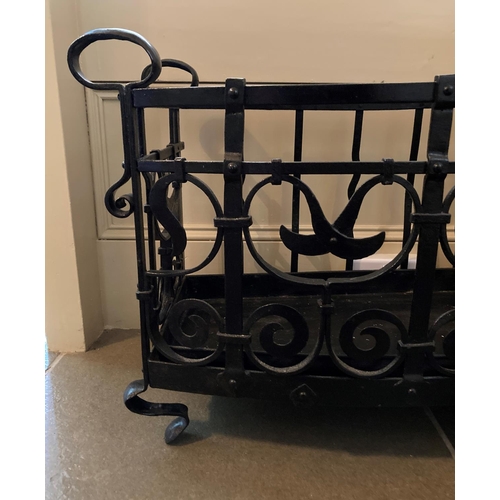 A wrought iron fire basket, bow fronted, of strapwork and scrollwork ...