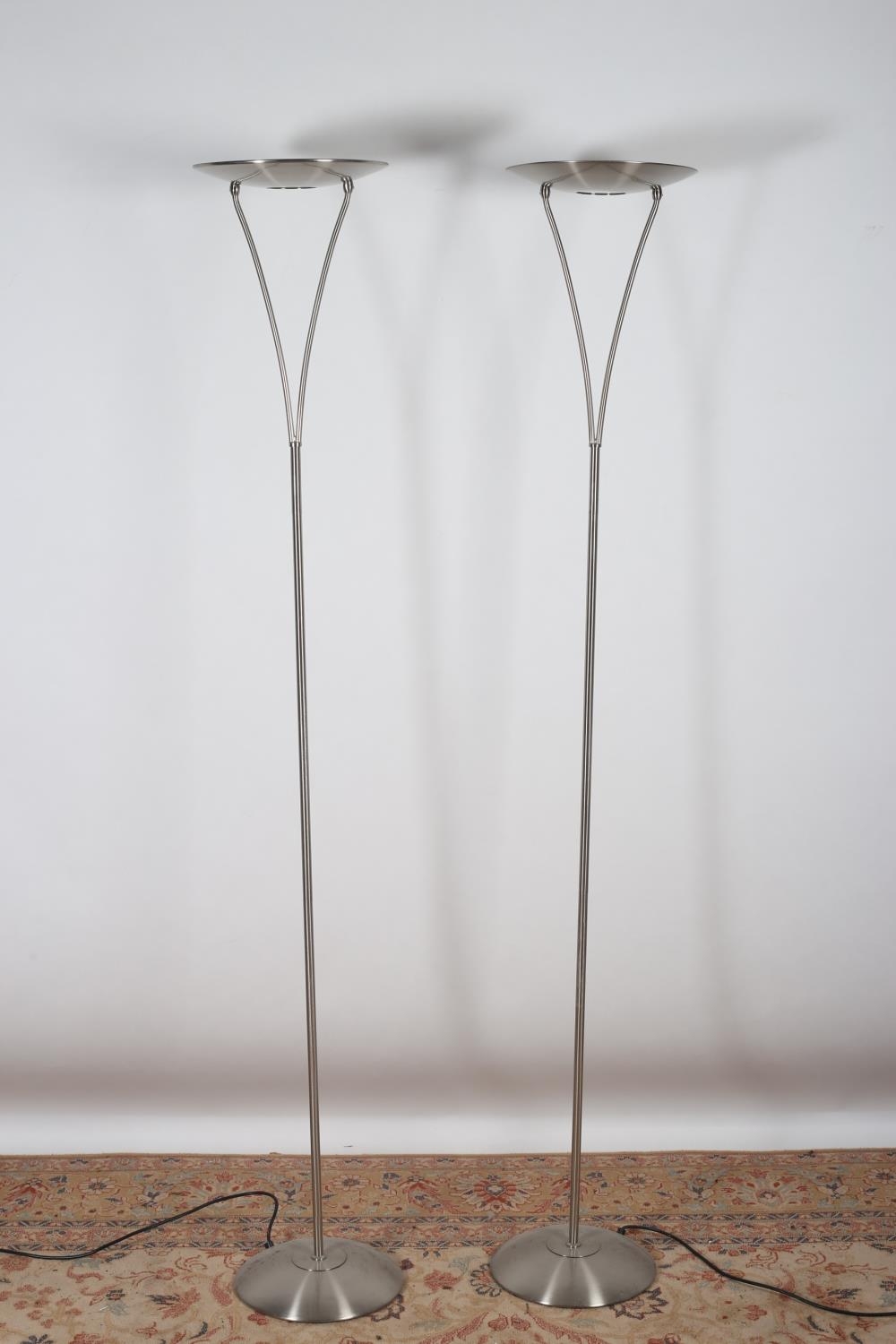 A PAIR OF WHITE METAL FLOOR STANDING UPLIGHTERS each with a cylindrical ...