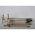 A SET OF THREE BRASS FIRE IRONS together with a pair of brass fire dogs ...