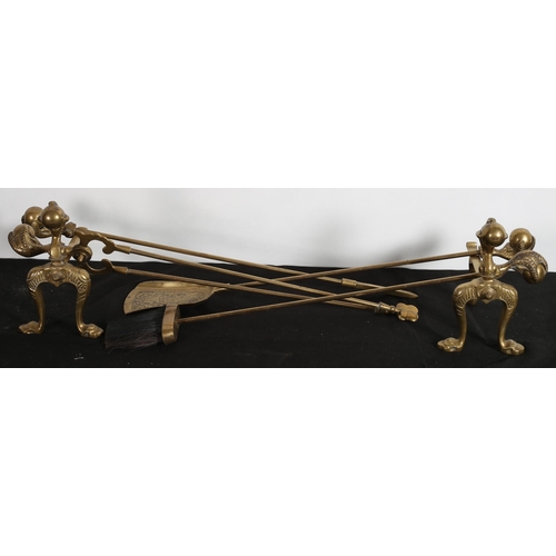 A SET OF THREE BRASS FIRE IRONS together with a pair of brass fire dogs ...