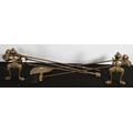 A SET OF THREE BRASS FIRE IRONS together with a pair of brass fire dogs ...