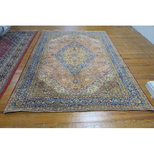 A WOOL RUG the light pink, light blue and indigo ground with central ...