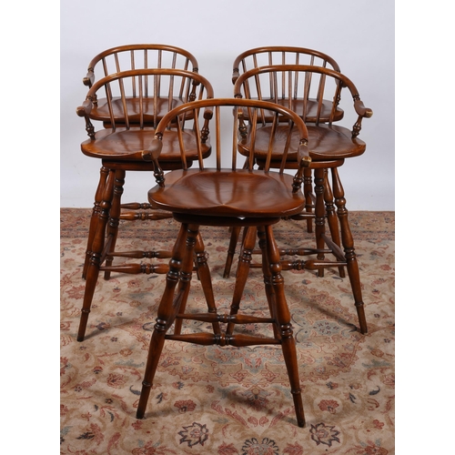 A SET OF FIVE ASHWOOD SWIVEL HIGH STOOLS each with a spindle splat ...
