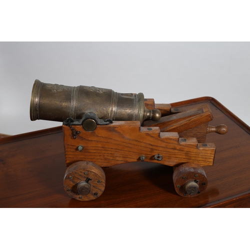 A SMALL DUTCH BRONZE NAVAL STARTER CANNON on an oak carriage with ...