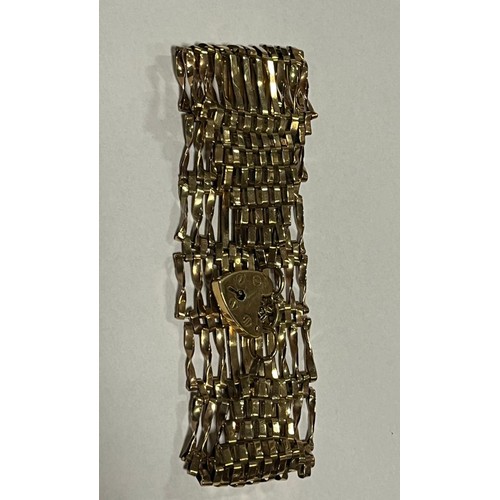 A 9CT GOLD GATE LINK BRACELET with lock and safety chain
