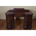 A VICTORIAN MAHOGANY DRESSING TABLE of rectangular bowed outline the ...
