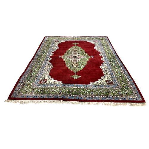 A LARGE ROYAL TABRIZ WOOL RUG the beige, light blue and wine ground ...