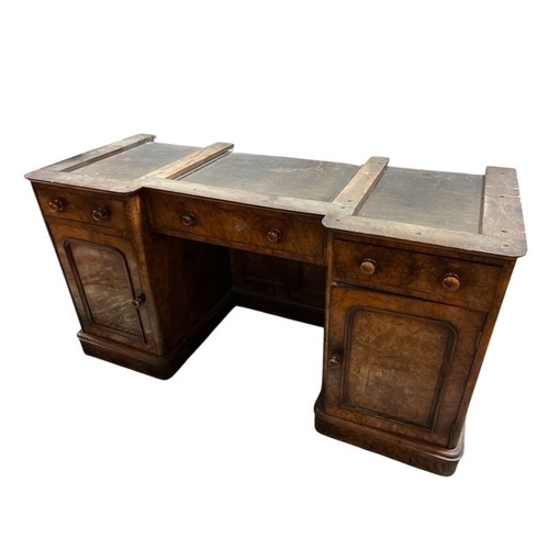 A VICTORIAN WALNUT DESK of inverted breakfront outline the shaped top ...