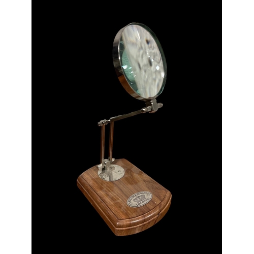 A CHROME AND HARDWOOD TABLE TOP MAGNIFYING GLASS with adjustable arm