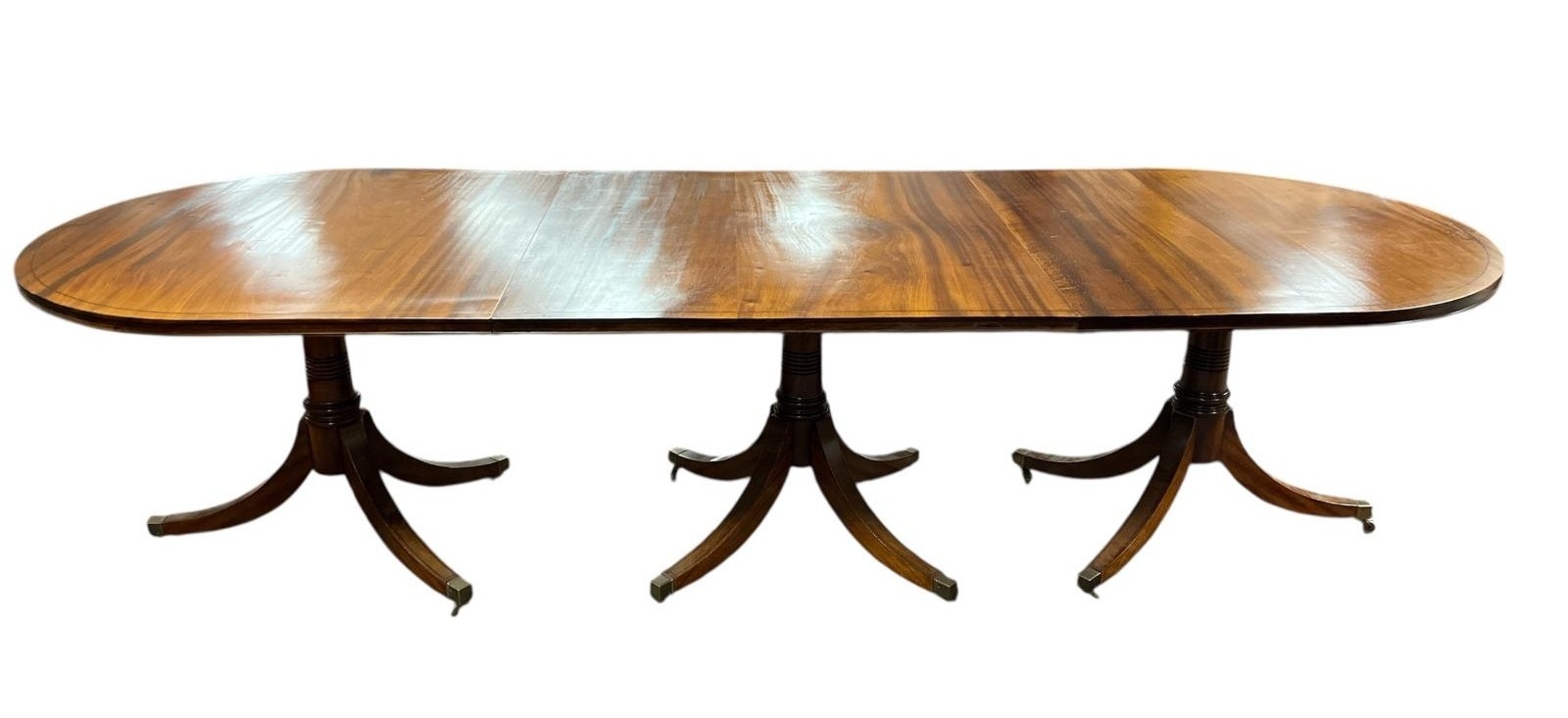 A 19TH CENTURY MAHOGANY THREE POD DINING TABLE of rectangular outline ...