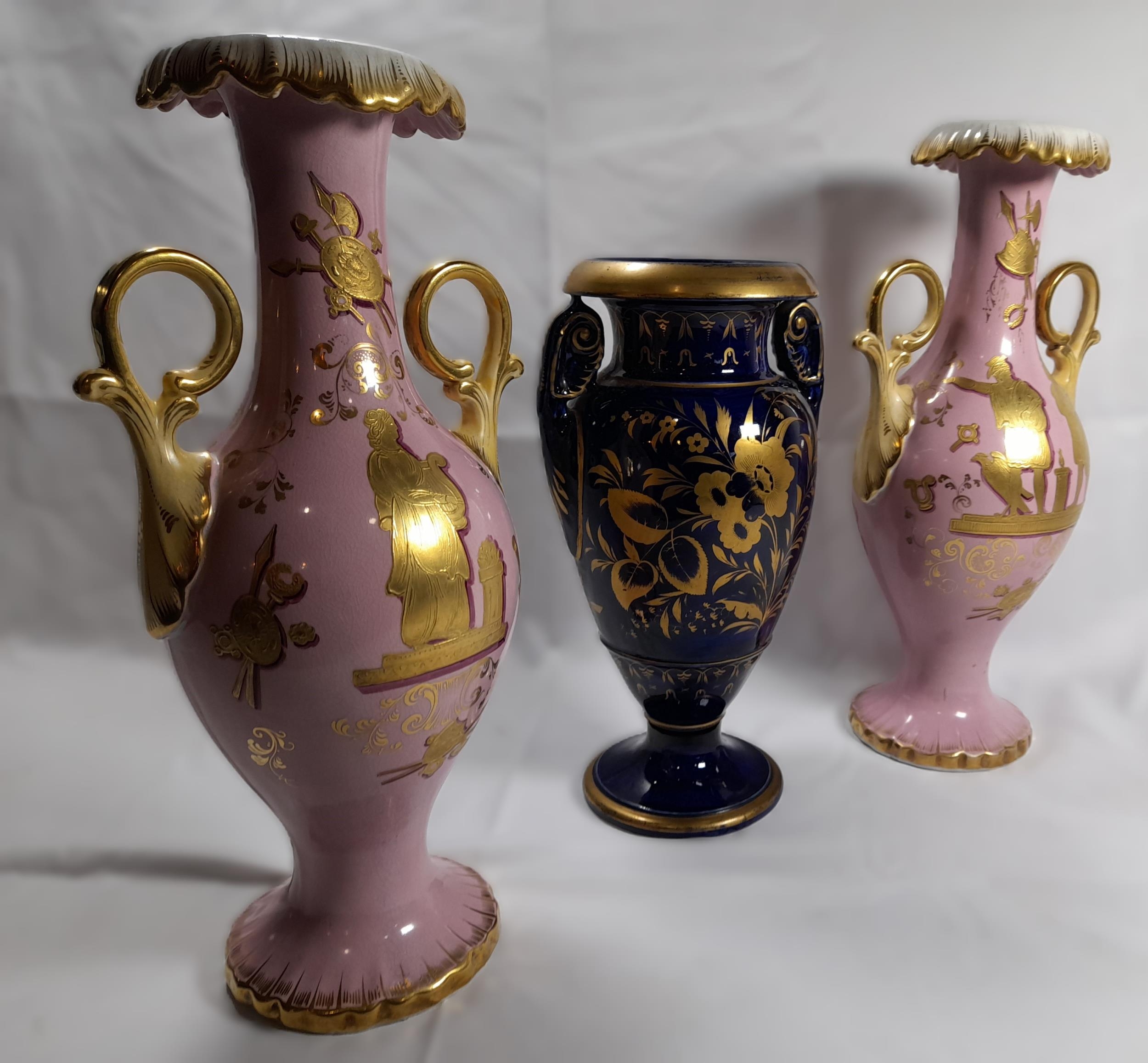 A PAIR OF CONTINENTAL PINK GLAZED VASES, the sides with Greco-Roman ...