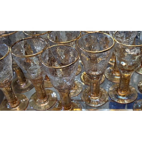 A large collection of antique gold rimmed crackle glass wine goblets ...