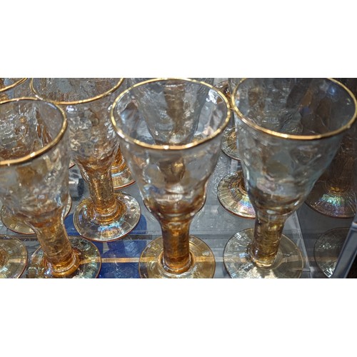 A large collection of antique gold rimmed crackle glass wine goblets ...