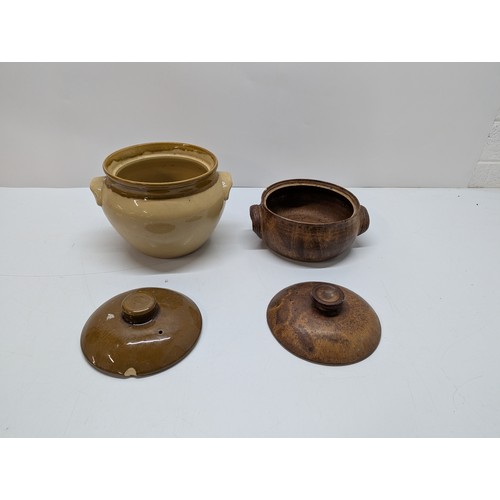 TWO LIDDED STONEWARE POTS Comprising a large cream-glazed preserving ...