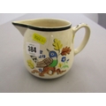ASHTEAD POTTERY MILK JUG with bird and floral decoration, with hairline ...