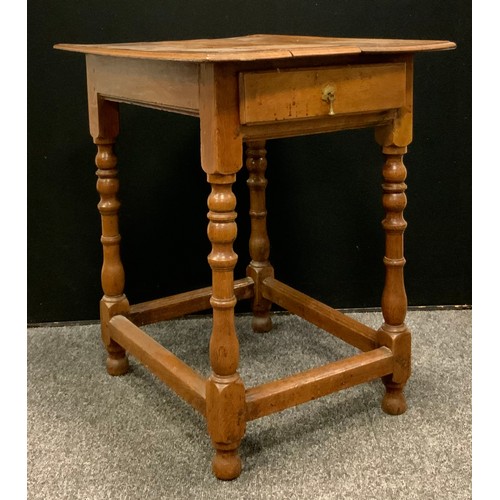 An early 18th century oak side table, of small proportions, oversailing ...