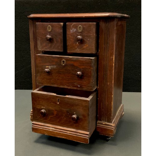 A Victorian pine miniature chest of drawers, rounded oversailing ...