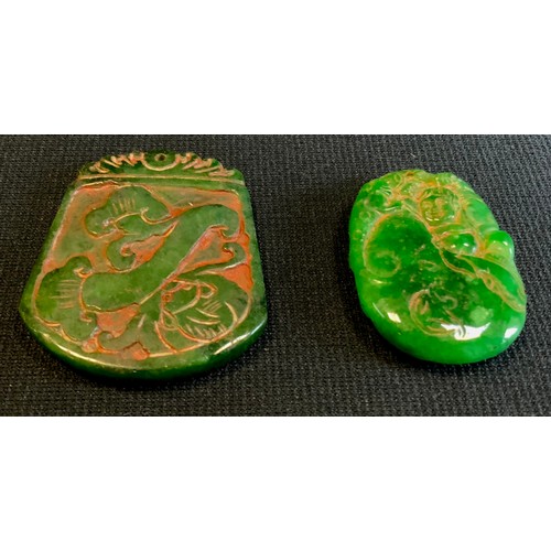 A pair of modern Chinese green stone carved pendants, possibly jade