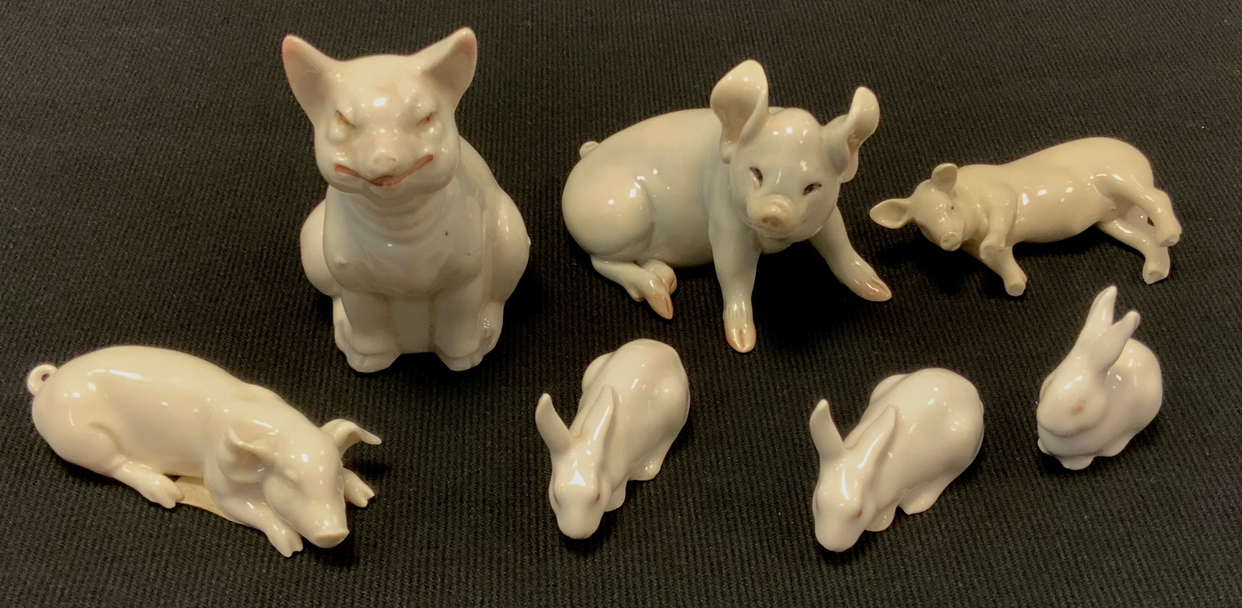 three Royal Copenhagen porcelain figures, Rabbits; others Hutschenreuther etc Pigs (7)