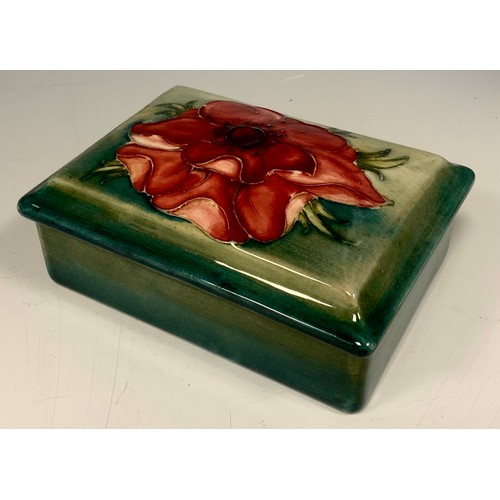 A Moorcroft rectangular lidded box, Hibiscus pattern lid, on a mossy ...