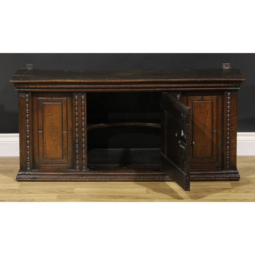 A late 17th/early 18th century oak wall-hanging provision cupboard, the ...