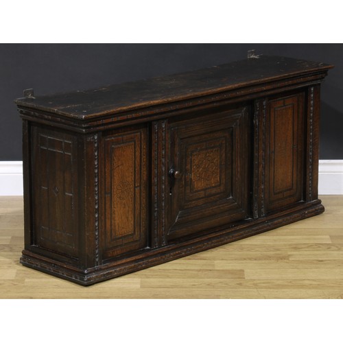 A late 17th/early 18th century oak wall-hanging provision cupboard, the ...