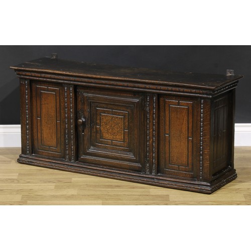A late 17th/early 18th century oak wall-hanging provision cupboard, the ...