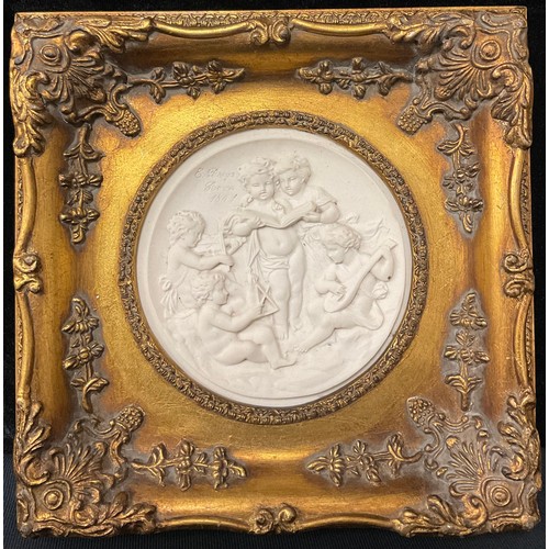 A reconstituted marble oval plaque in relief, after the antique, ornate ...
