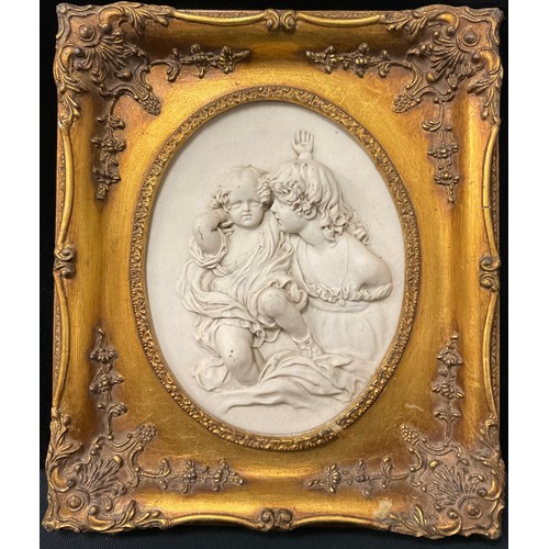 A reconstituted marble oval plaque in relief, after the antique, ornate ...