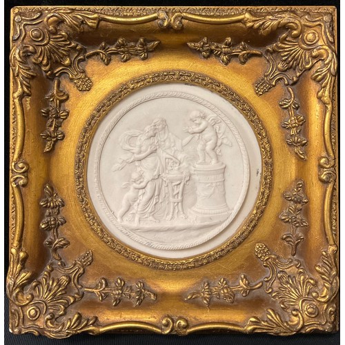 A reconstituted marble oval plaque in relief, after the antique, ornate ...