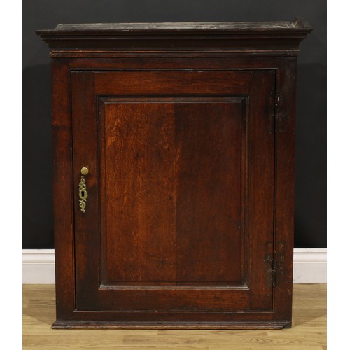 A George III oak wall hanging provision cupboard, raised and fielded ...
