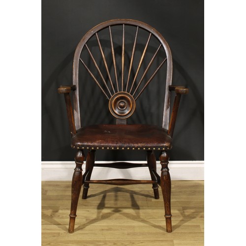 An Arts & Crafts period oak Windsor elbow chair, hoop back with nine ...