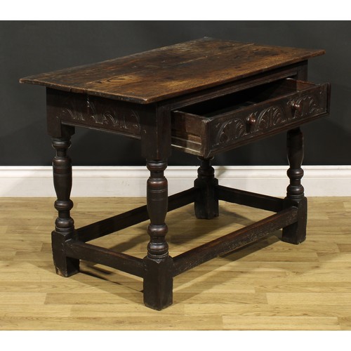 A 17th century oak side table, oversailing top above a long frieze ...