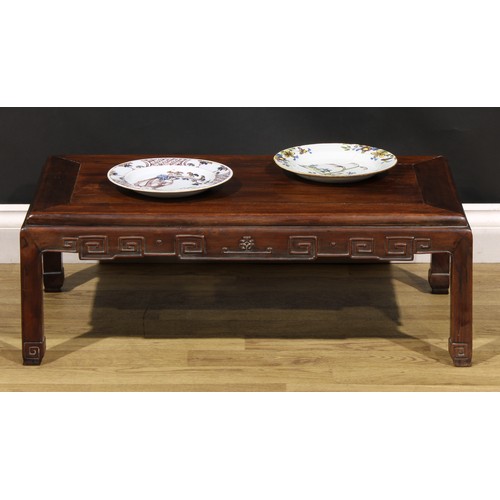 A Chinese hardwood low tea table, panel top, shaped apron carved with ...