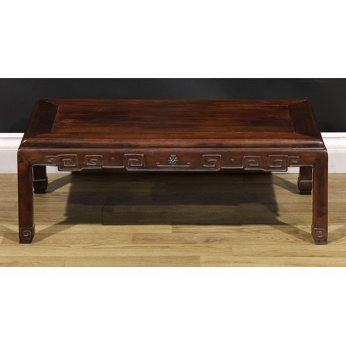 A Chinese hardwood low tea table, panel top, shaped apron carved with ...