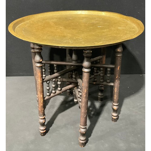 A Benares brass topped folding table, 63.5cm wide, 52cm high