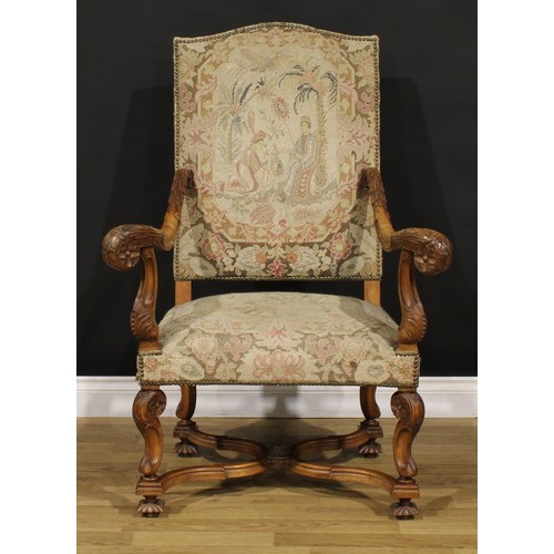 A Baroque walnut armchair, outswept arms boldly carved with acanthus ...