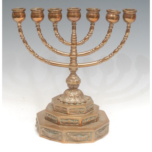 Judaica - an early 20th century brass Jewish Menorah, the stepped ...