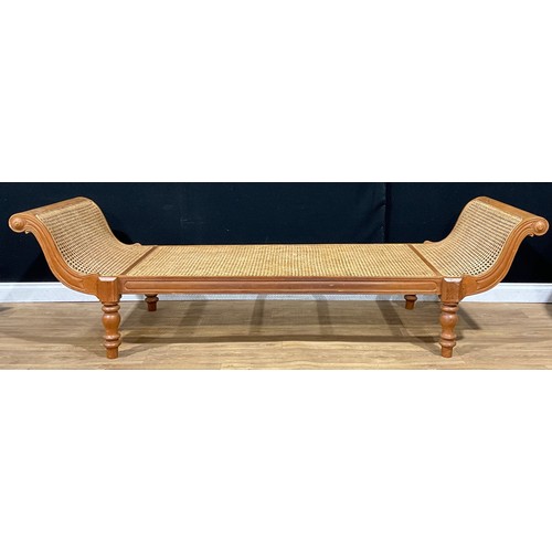 A Colonial teak plantation daybed, of Regency design, cane seat, turned ...