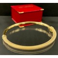 An 18ct gold scale textured and plain tew section hinge bangle, stamped ...