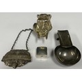An Edwardian silver cigar rest, London 1902; a filled silver novelty ...
