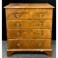 A George II walnut chest, crossbanded oversailing top above two short ...