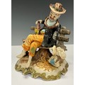 A Capodimonte porcelain figure, tramp sat on a bench, he sits without ...