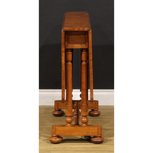 A Victorian satinwood Sutherland table, rounded rectangular top with ...