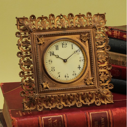 An Aesthetic Movement gilt metal strut type easel timepiece, 9cm enamel ...