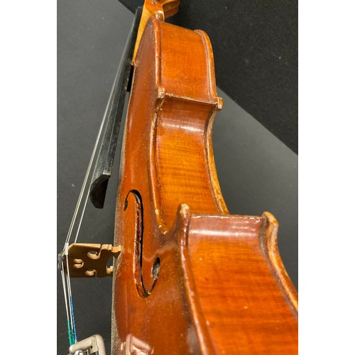 A violin, the two-piece back 37.5cm long, outlined throughout with ...