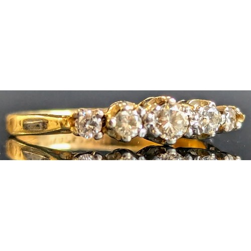 An 18ct gold five stone graduated diamond ring, set with five graduated ...