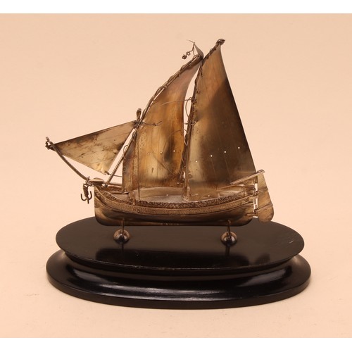 A Maltese silver model, of a sailing boat, ebonised plinth, 14.5cm long