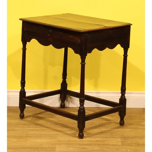 A William III oak side table, oversailing two-plank top above a frieze ...