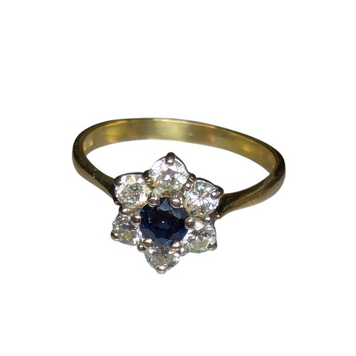 An 18ct gold diamond and sapphire flower head cluster ring, set with an ...